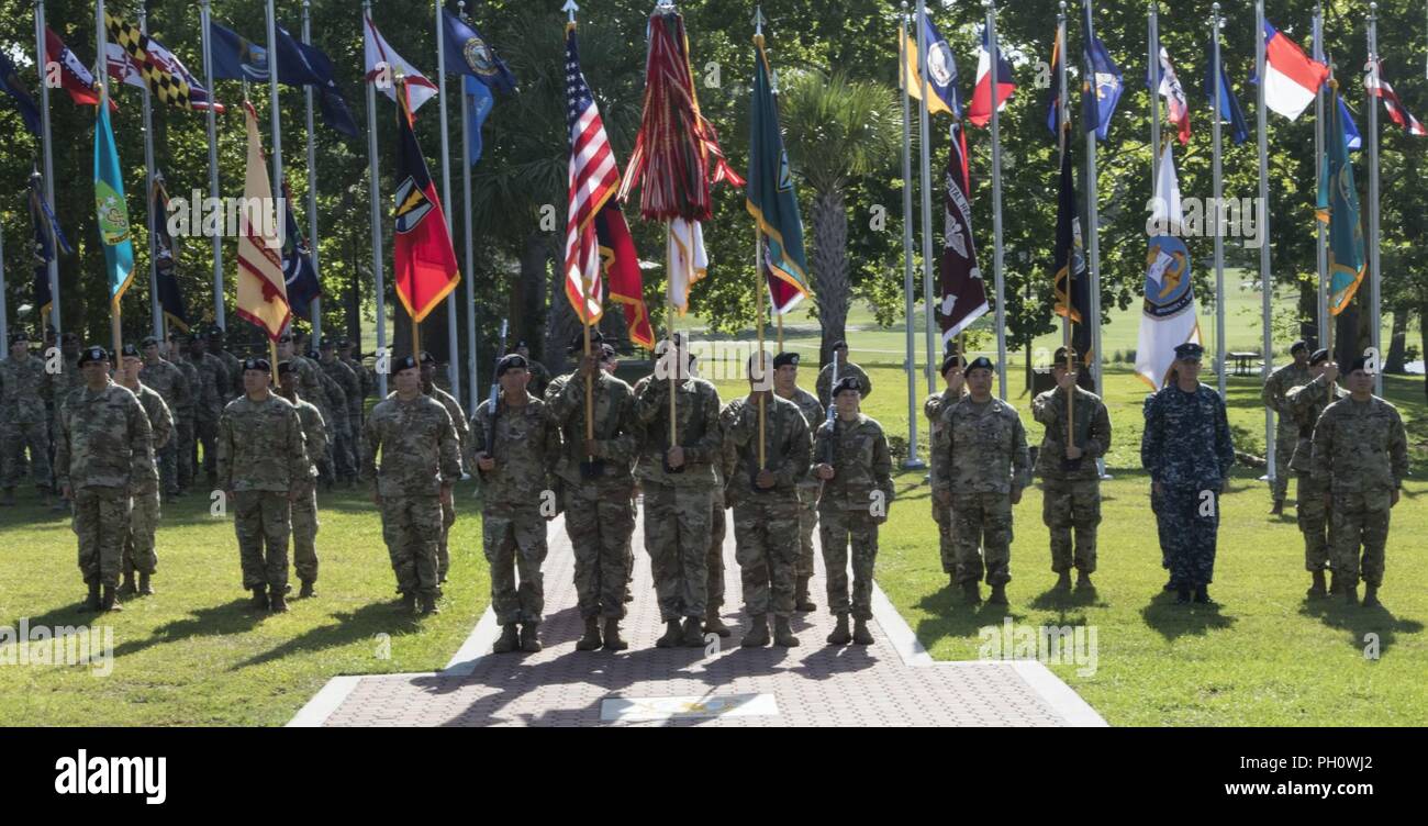 Commanders and their unit colors stand at attention during the Fort ...