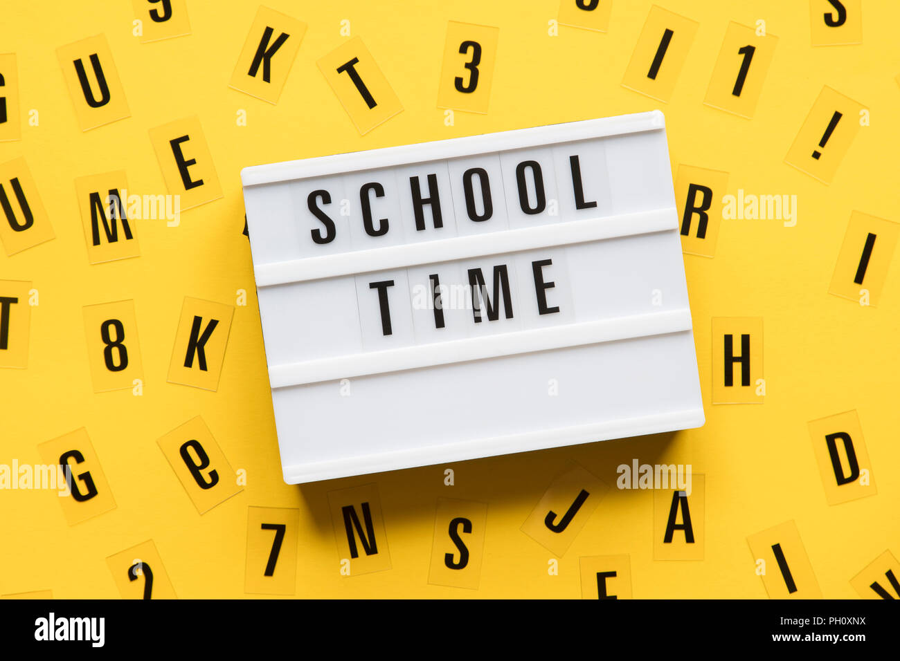 School time lightbox message on a bright yellow background Stock Photo ...