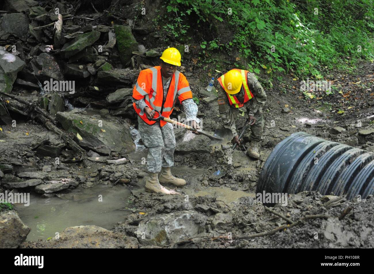 Staff Sgt. Carlyle Maynard, 662nd Engineer Support Company shovels mud ...