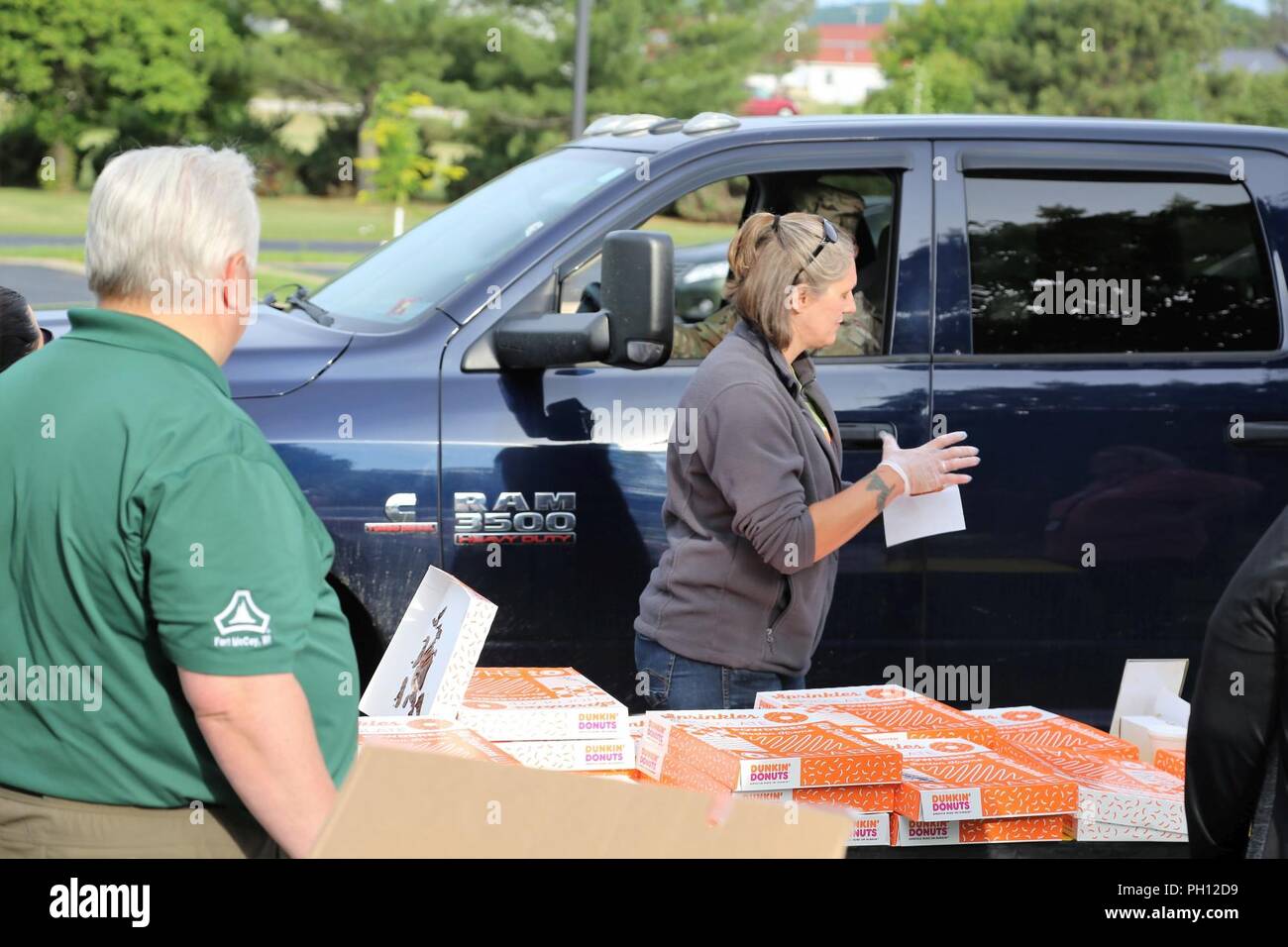 Fort McCoy, Wis., community members line up for a free drive-thru ...