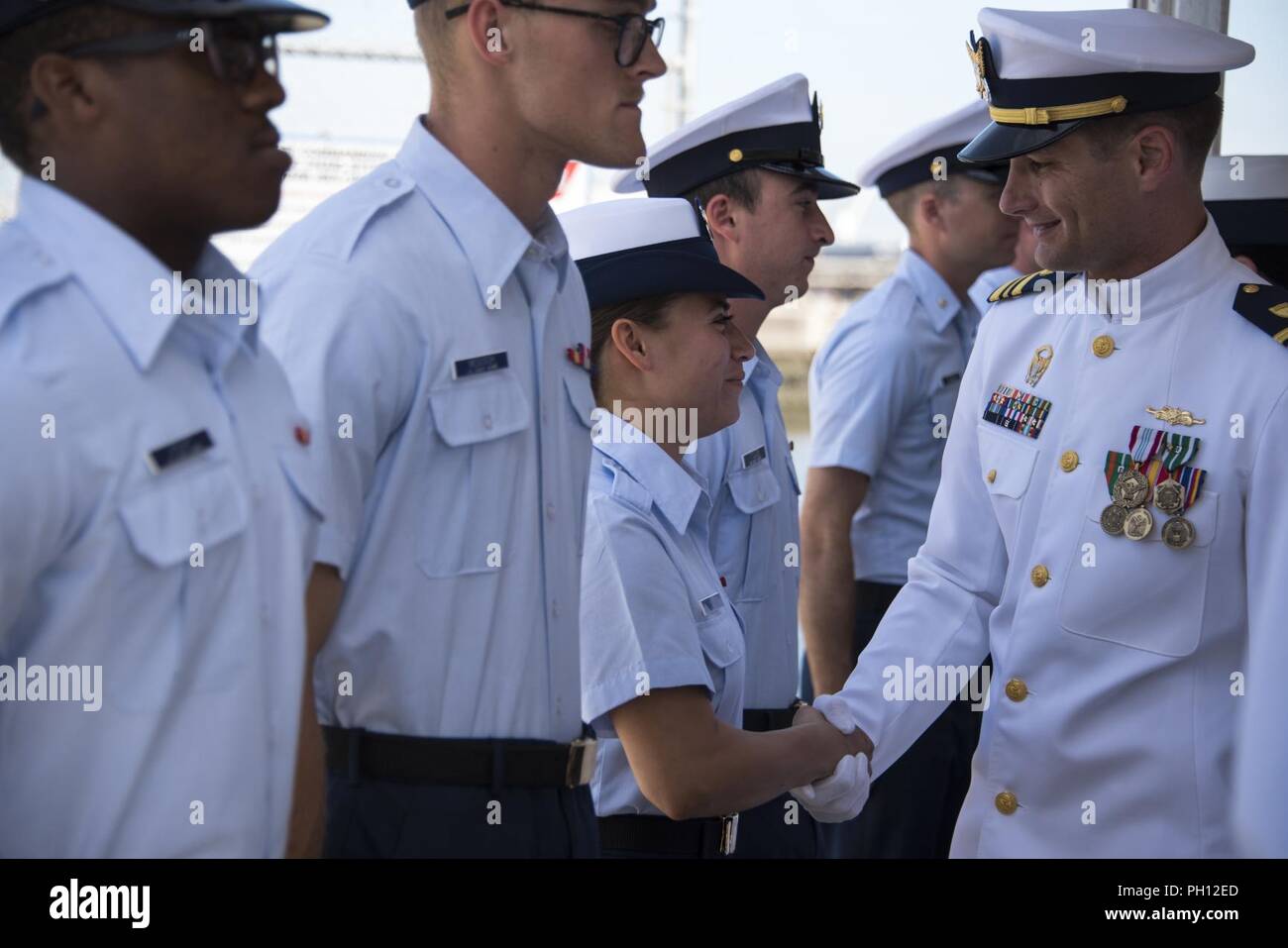 Lt. Cmdr. Brendan Harris conducts a personnel inspection of the Coast ...