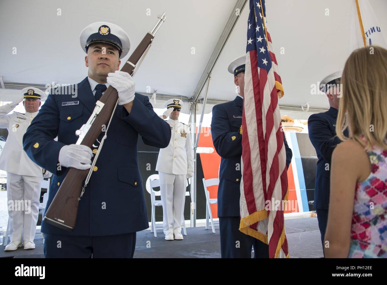 A Coast Guard color guard presents the colors during a change of ...