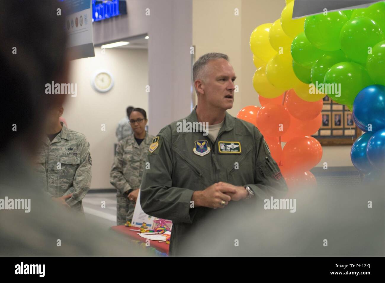 Col. Michael Miller, 2nd Bomb Wing commander, speaks during an LGBT ...