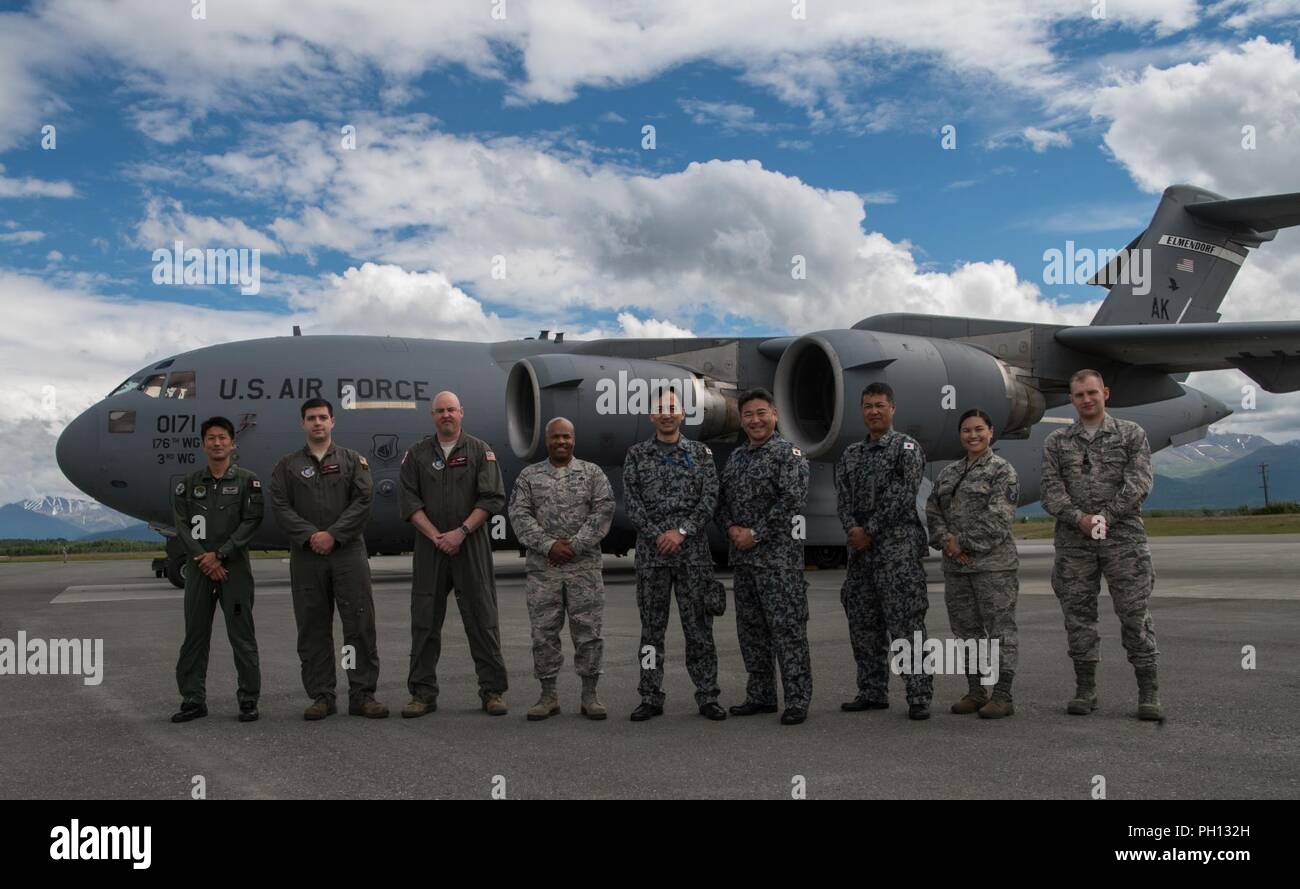 U.S. and Japan Air Self-Defense Force Airmen pose for a photo in front ...