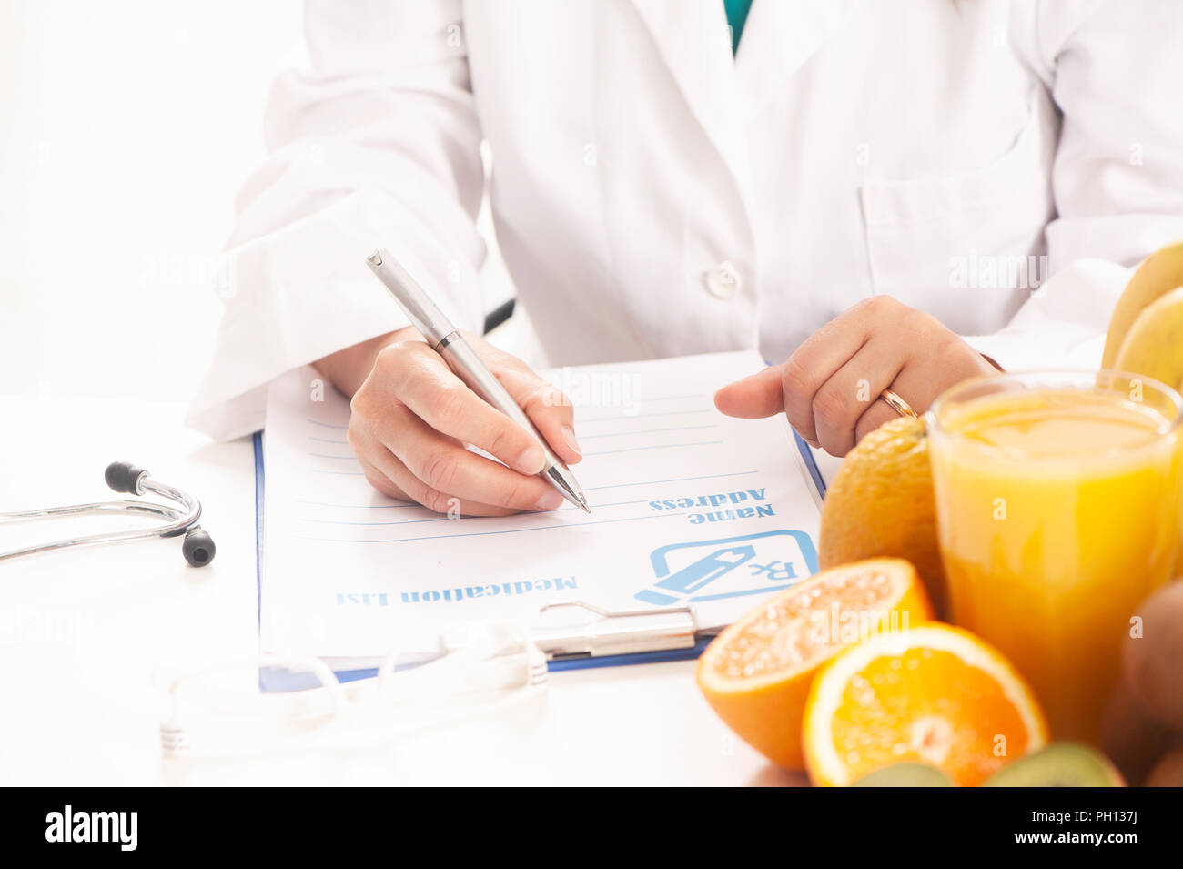 Nutritionist writing medical records and prescriptions with fresh ...