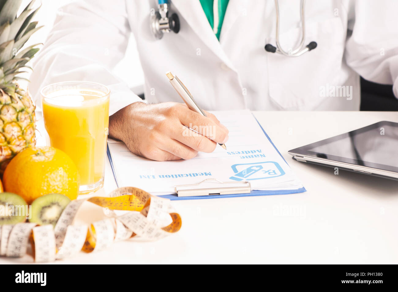 Nutritionist writing medical records and prescriptions with fresh ...