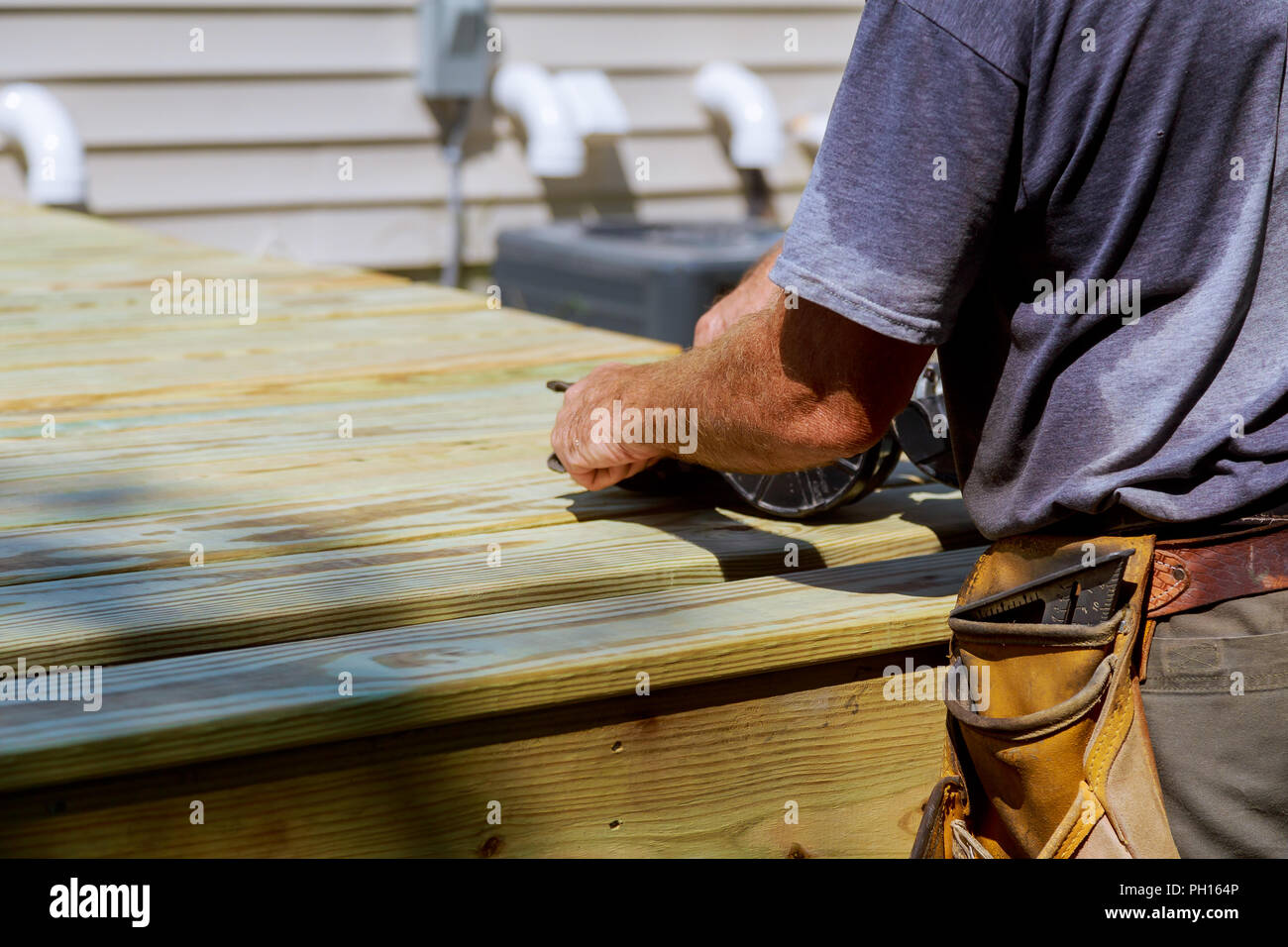 Backyard Deck Reconstruction handsome man carpenter installing wood ...