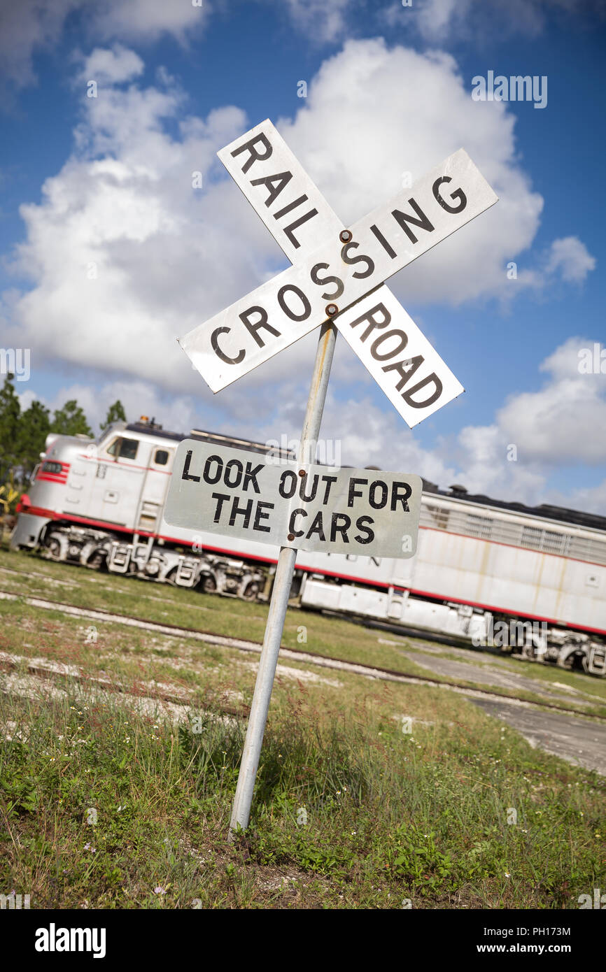 Rail road crossing sign on the train station outdoors on sky background ...
