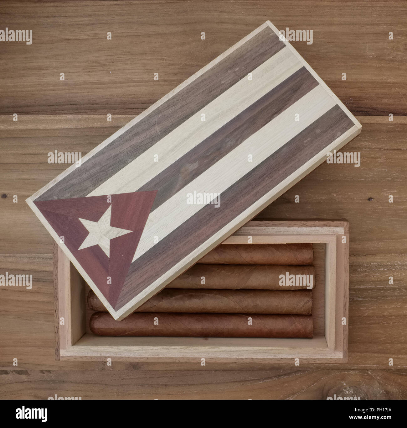 Studio scene of Cuban cigars and vintage cigar box on old wooden table ...