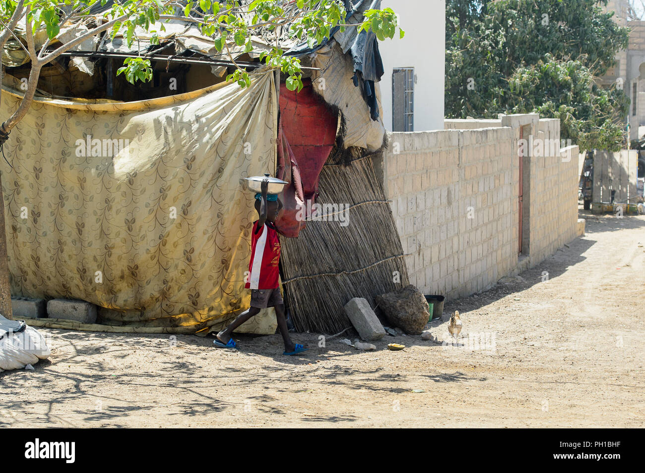 ROAD TO LAMPOUL, SENEGAL - APR 23, 2017: Unidentified Senegalese little ...