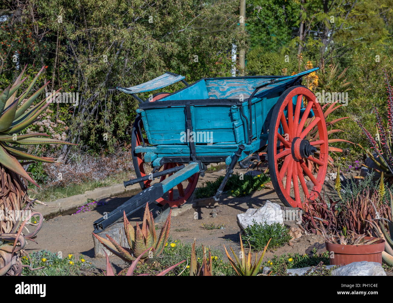 Retro blue colored horse drawn cart with bright red wheels image in ...