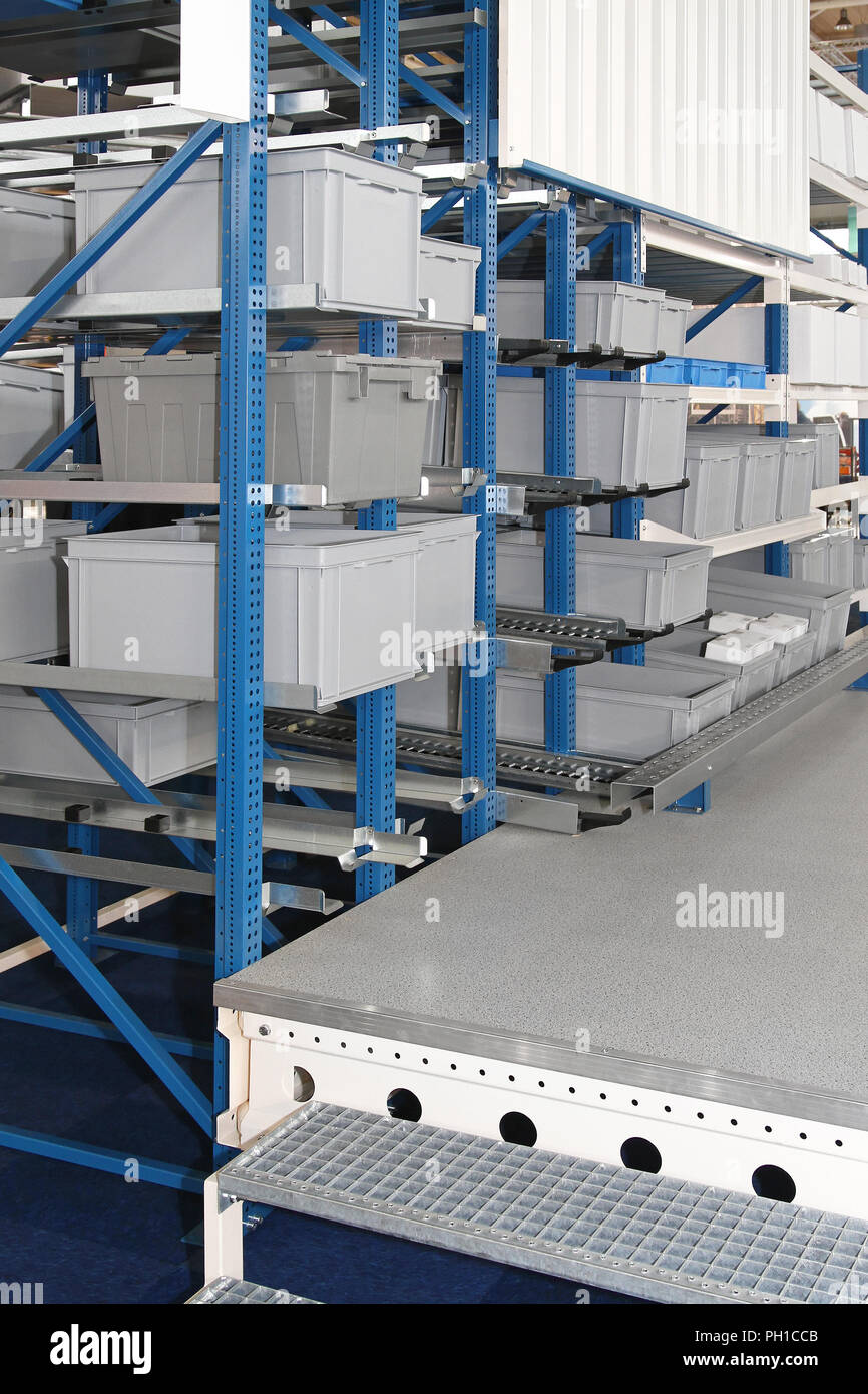 Plastic crates and boxes in storage shelving Stock Photo - Alamy