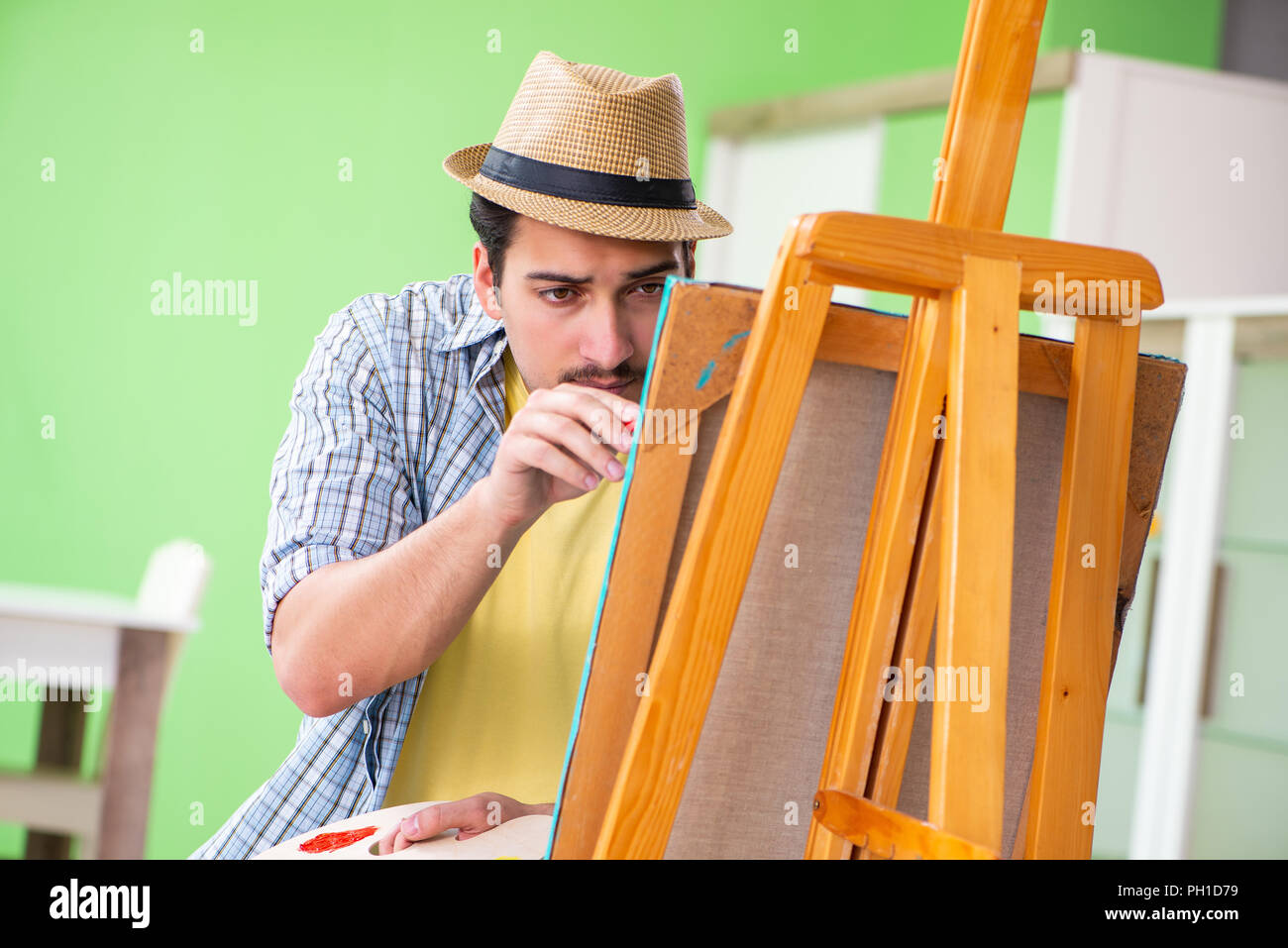 Young male artist working on new painting in his studio Stock Photo - Alamy