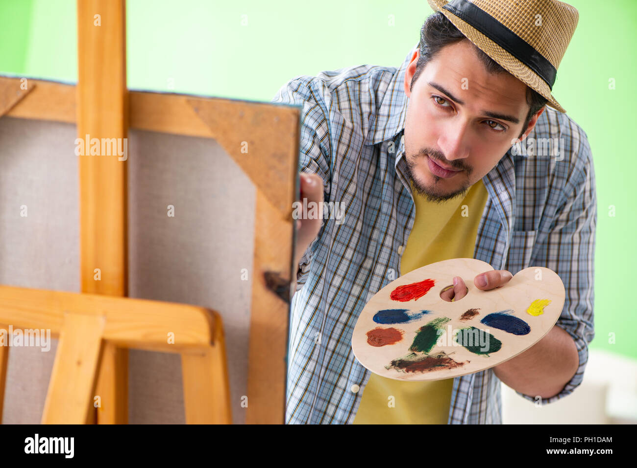 Young male artist working on new painting in his studio Stock Photo - Alamy