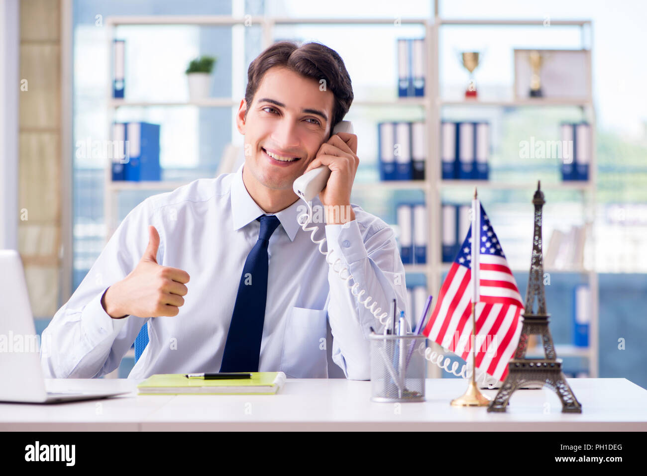 Sales agent working in travel agency Stock Photo - Alamy