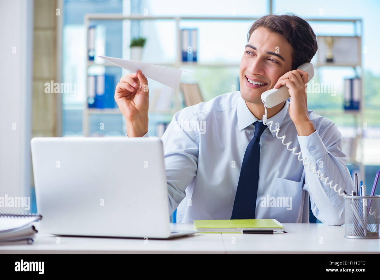 Sales agent working in travel agency Stock Photo - Alamy
