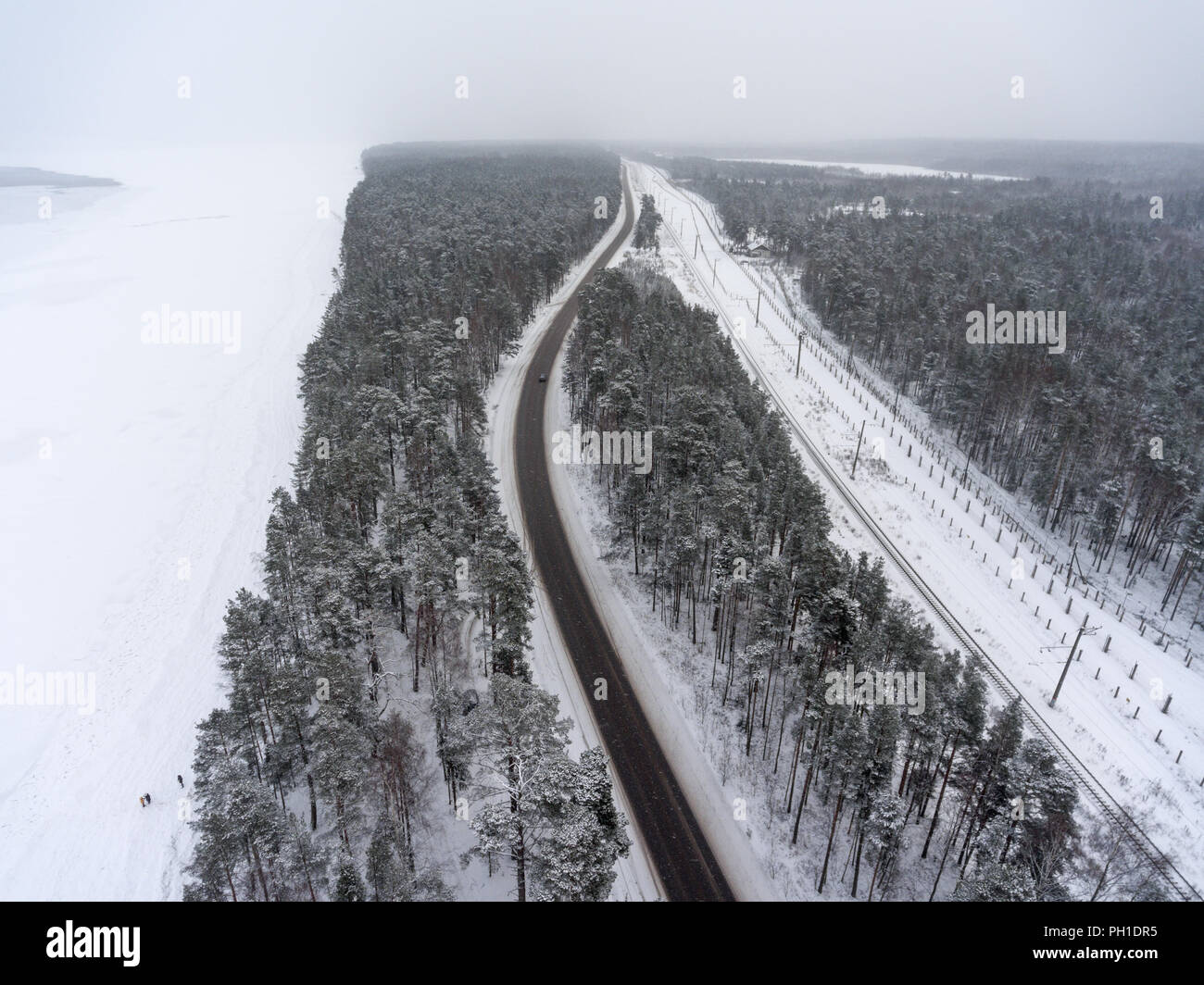 Aerial view at parallel highway and railroad range winter sea coast ...