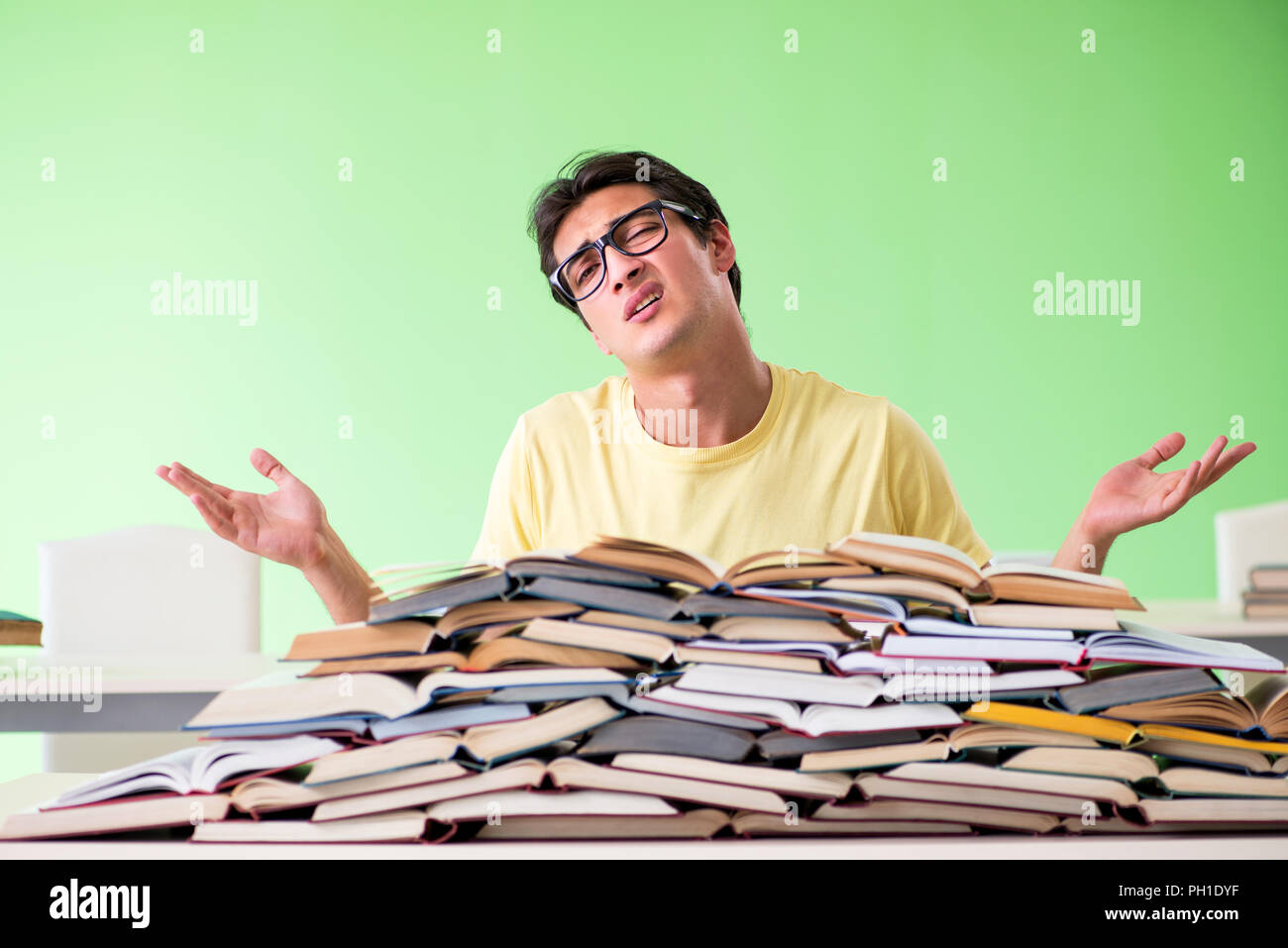 Student with too many books to read before exam Stock Photo - Alamy
