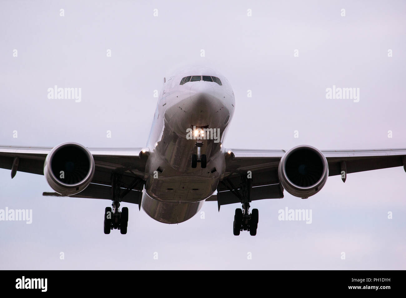 Airplane on final approach, close up. Landing of airplane in a sky ...