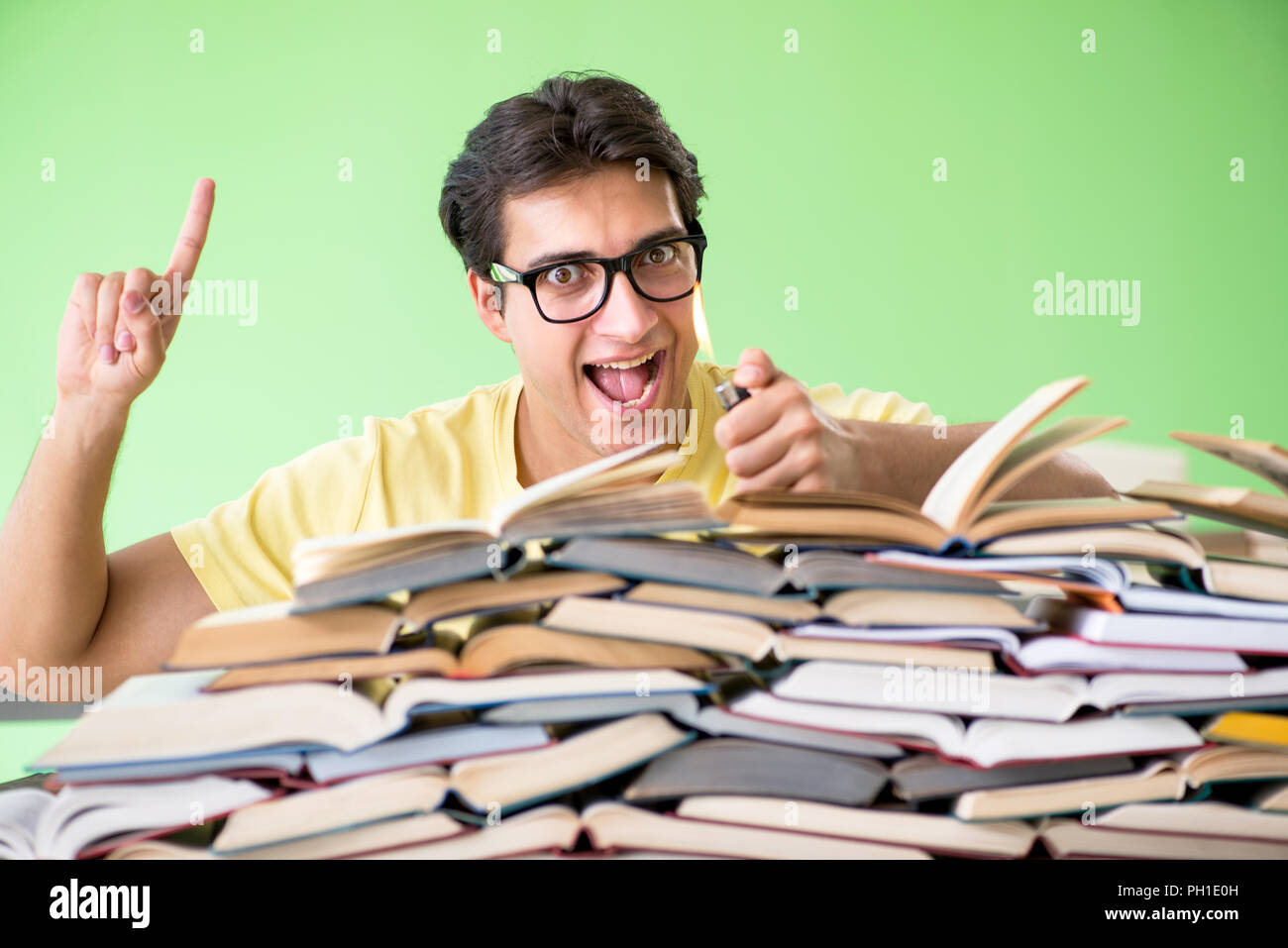 Student with too many books to read before exam Stock Photo - Alamy