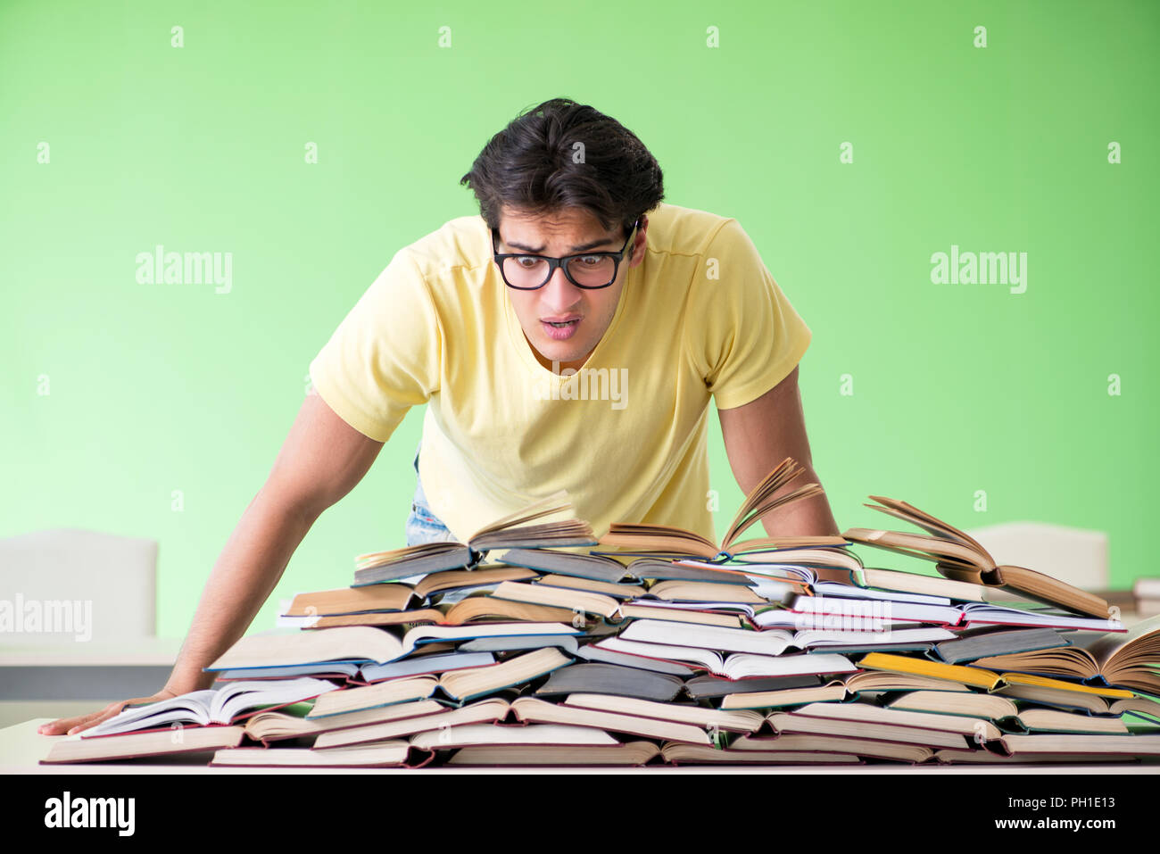 Student with too many books to read before exam Stock Photo - Alamy