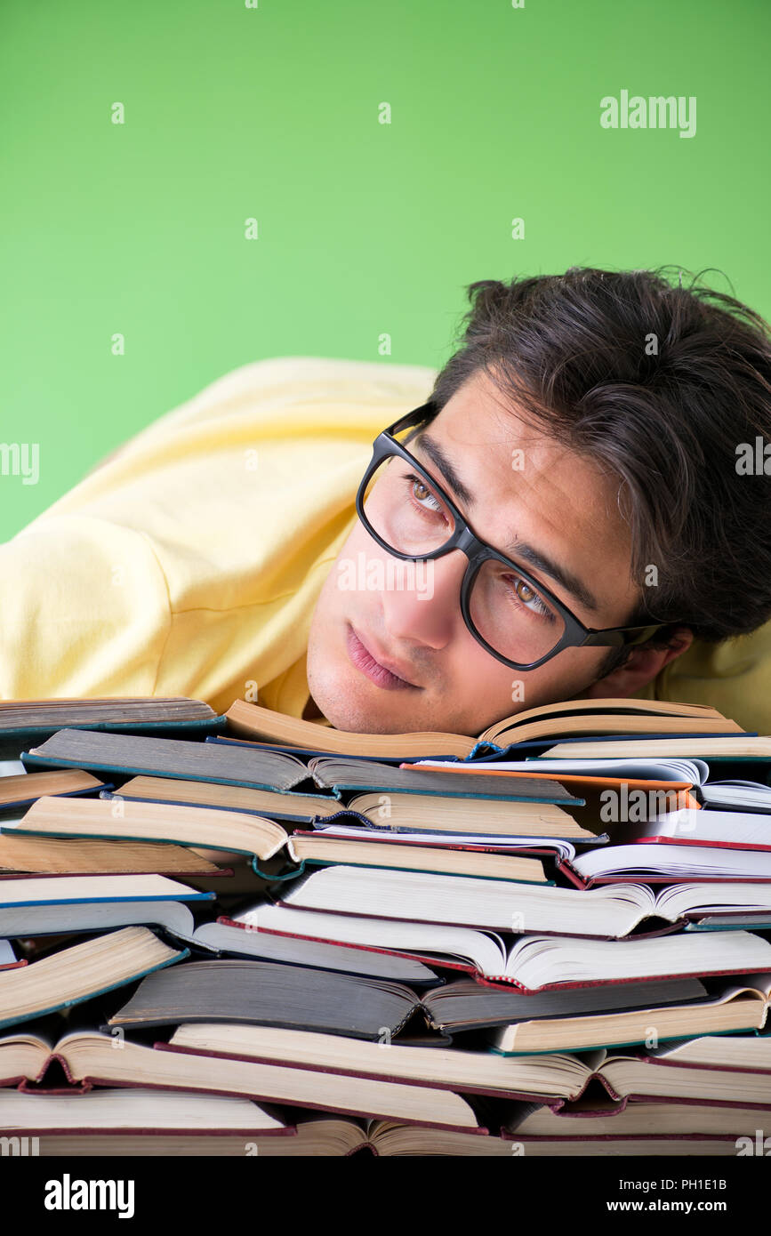 Student with too many books to read before exam Stock Photo - Alamy