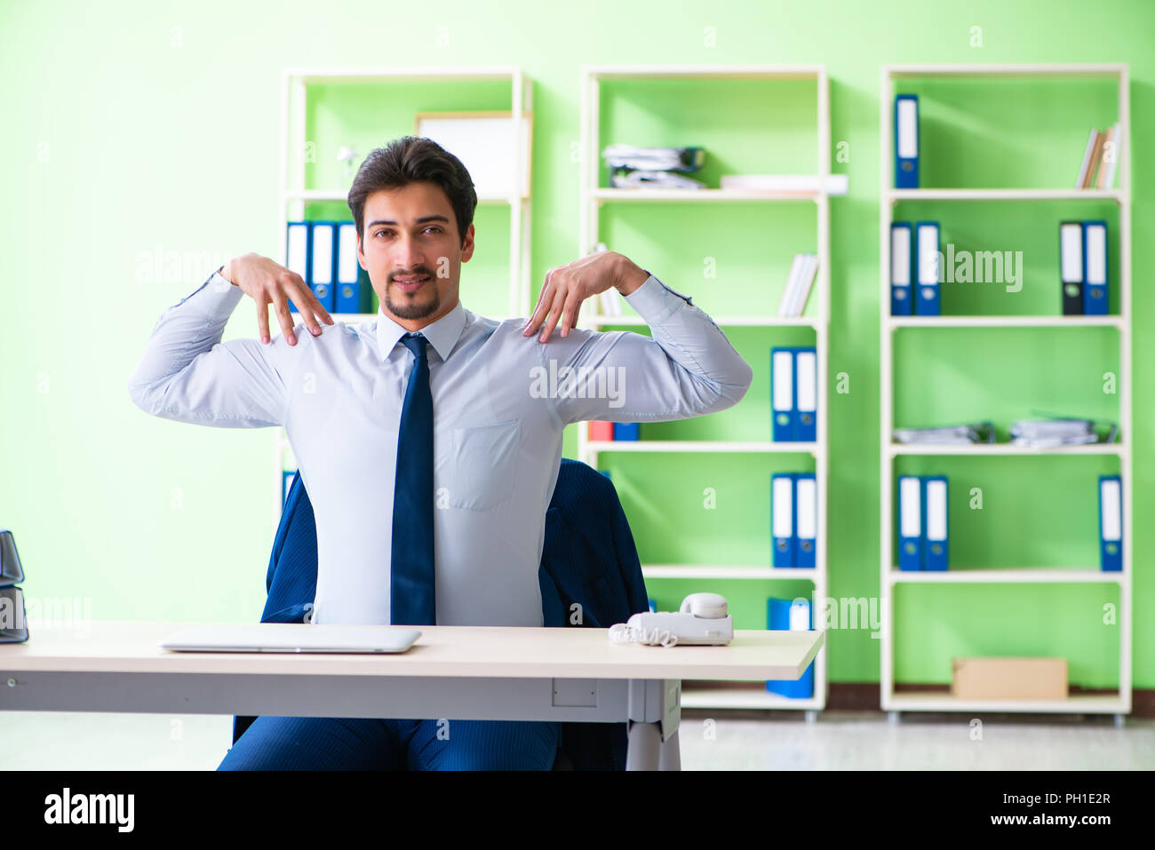 Employee doing exercises during break at work Stock Photo - Alamy