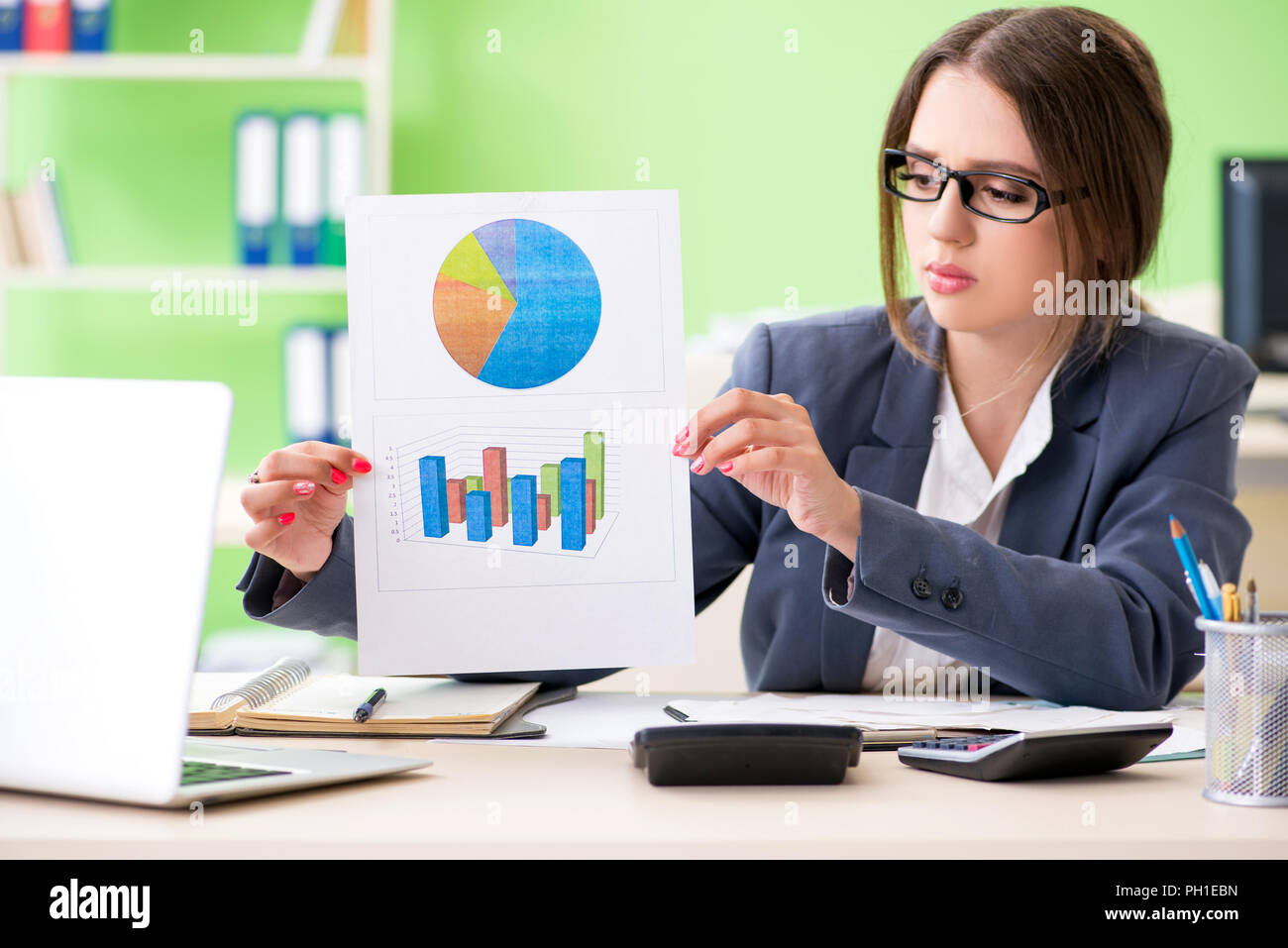 Female financial manager presenting graph chart sitting in the office ...