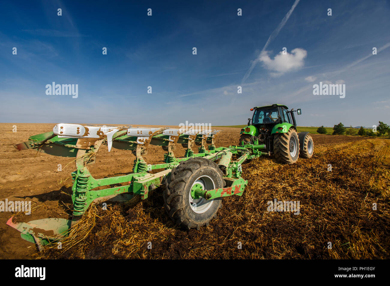 Tractor working on the farm, modern agricultural transport, farmer ...