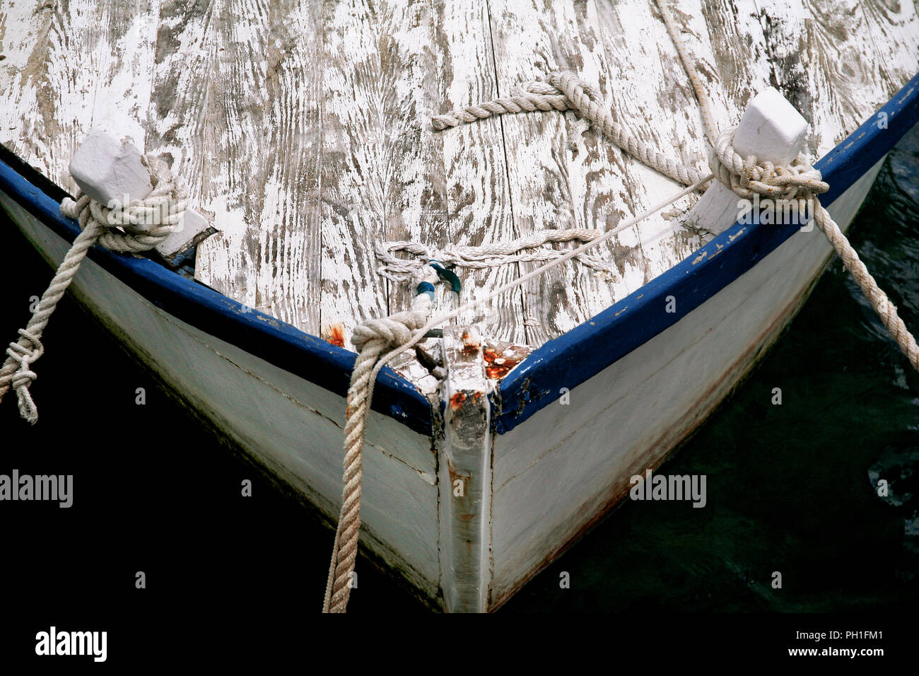 Bow of fishing boat with rope. Bow of blue and white fishing boat with ...