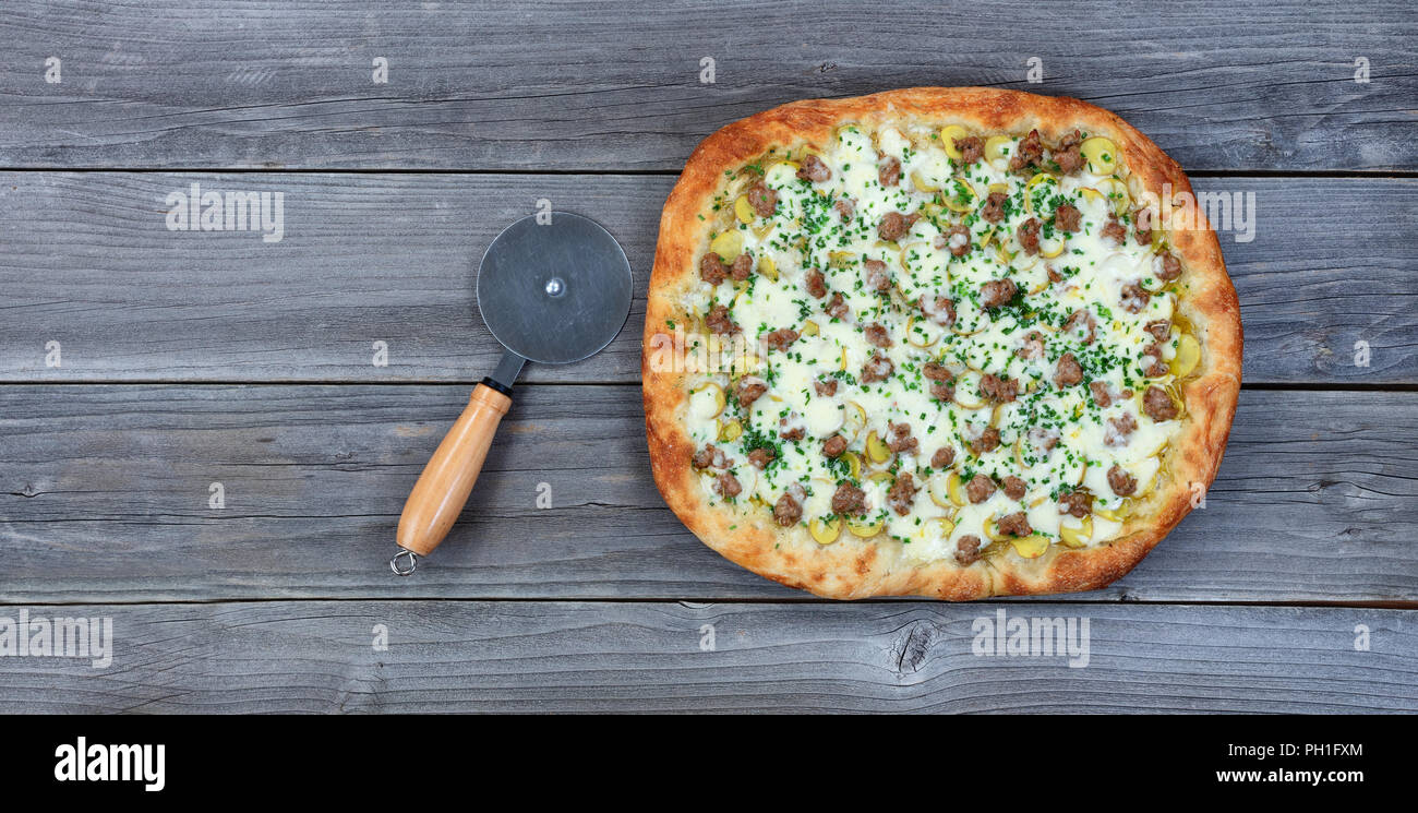 Top view of homemade cooked pizza with cutter on rustic wood Stock ...