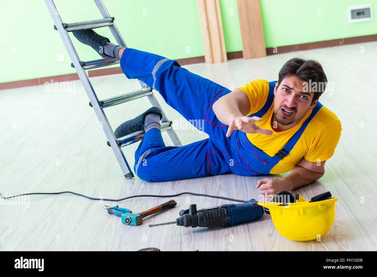 Injured worker at the work site Stock Photo - Alamy
