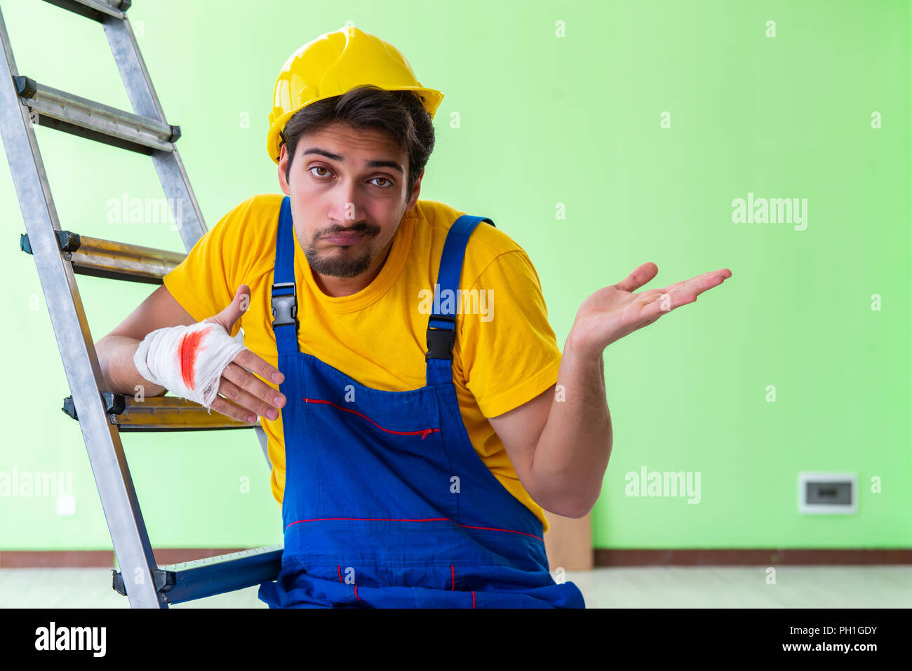 Injured worker at the work site Stock Photo - Alamy