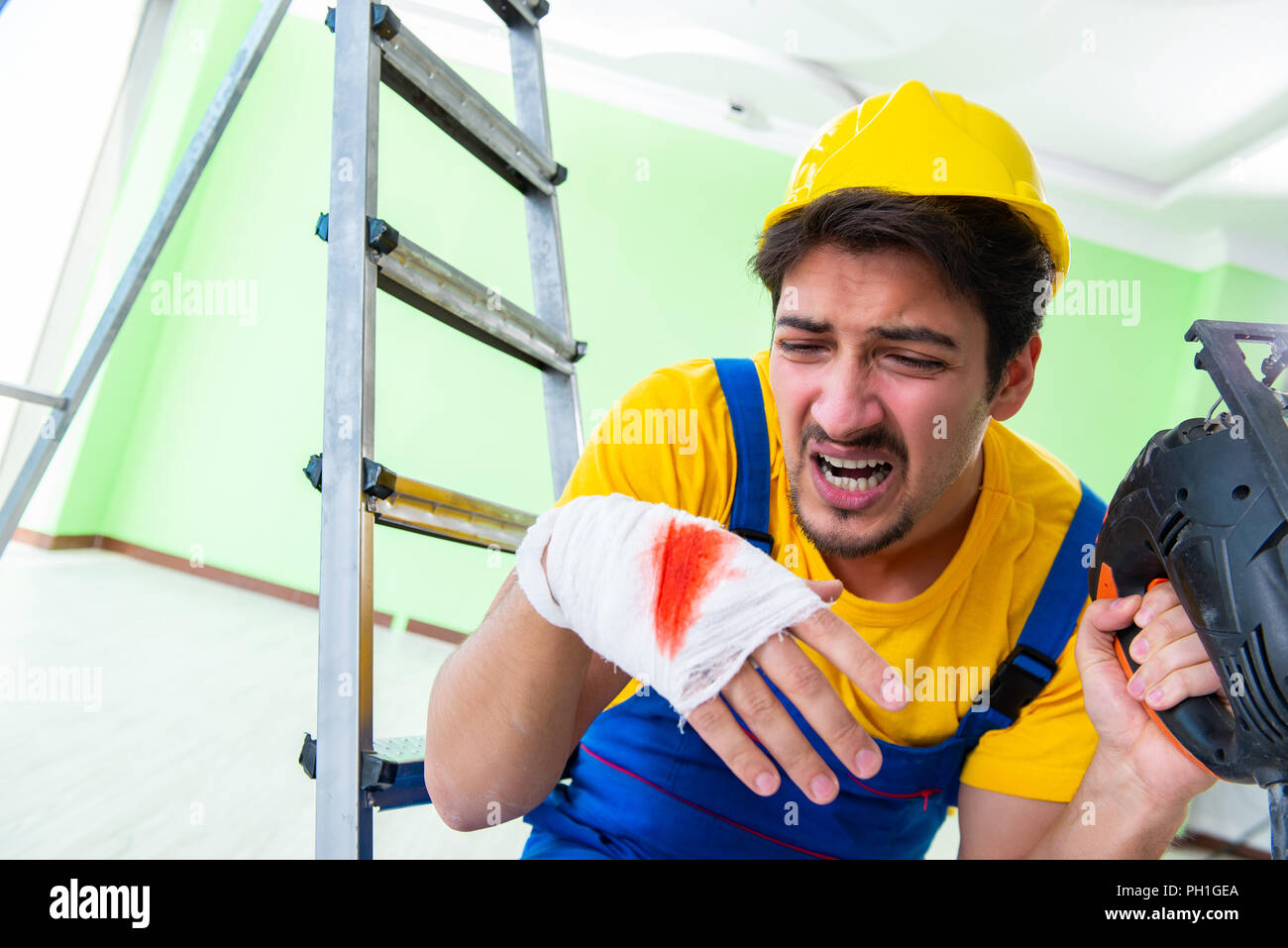 Injured worker at the work site Stock Photo - Alamy