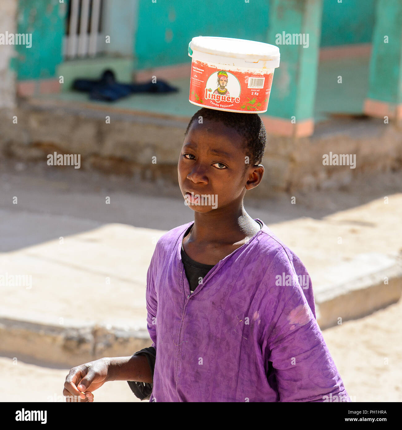 African kid bucket on head hi-res stock photography and images - Alamy