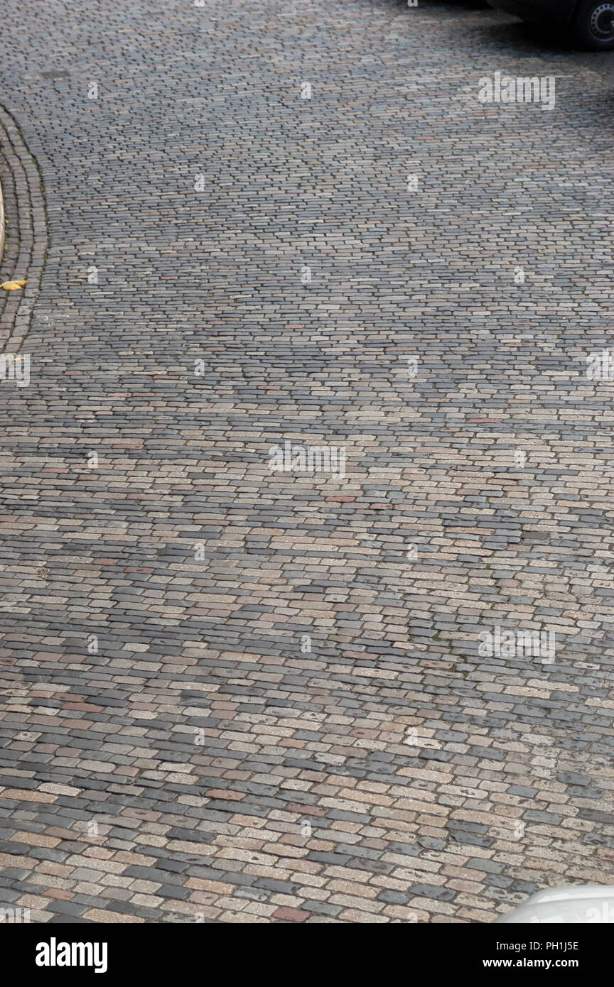 A view from above of a very empty semi circular cobbled road, made from ...