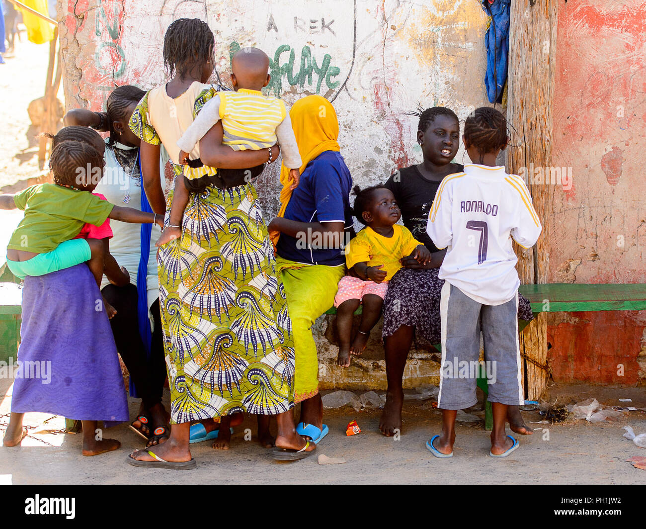 SAINT LOUIS, SENEGAL - APR 24, 2017: Unidentified Senegalese people sit ...