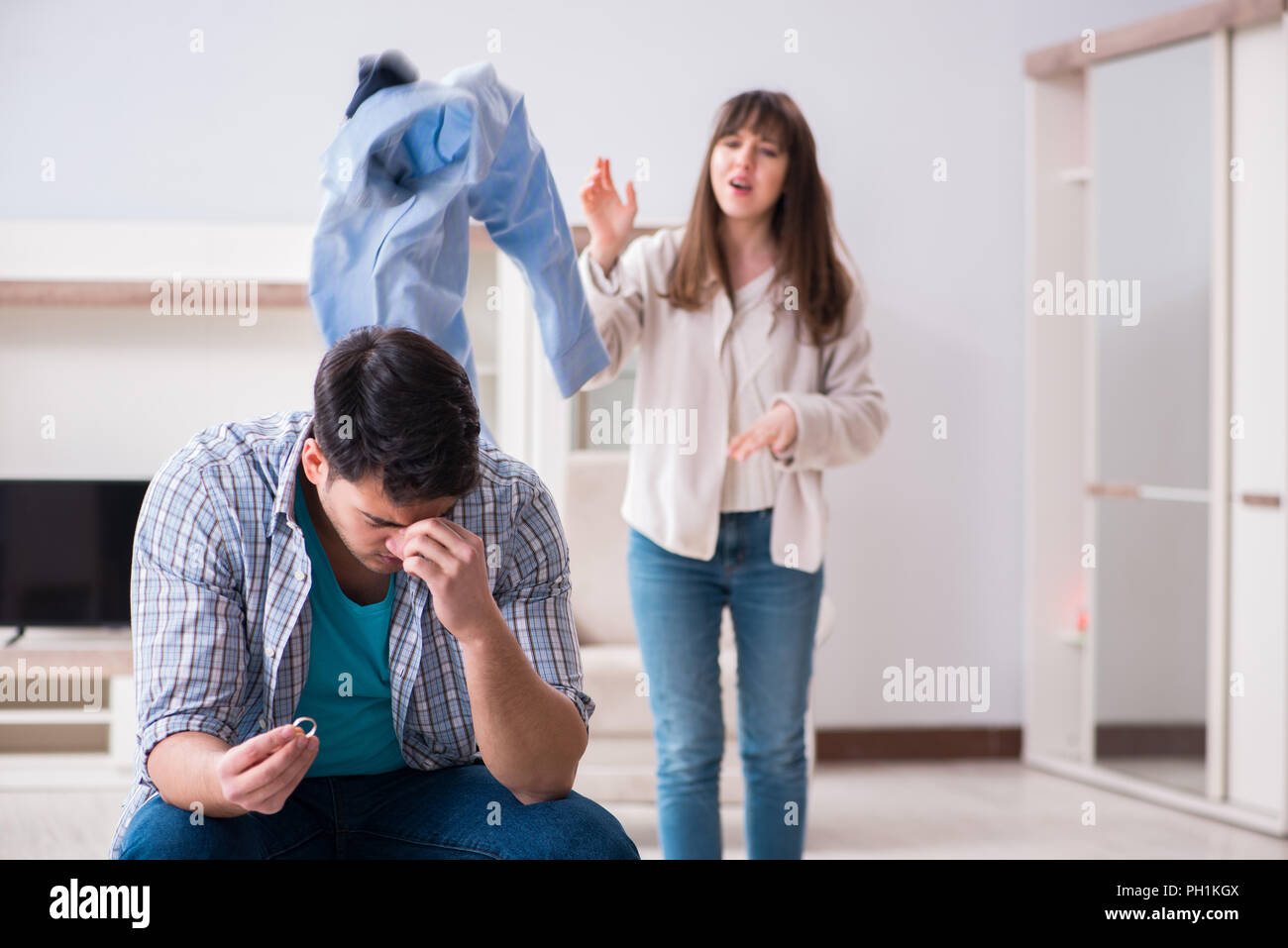 Woman evicting man from house during family conflict Stock Photo - Alamy