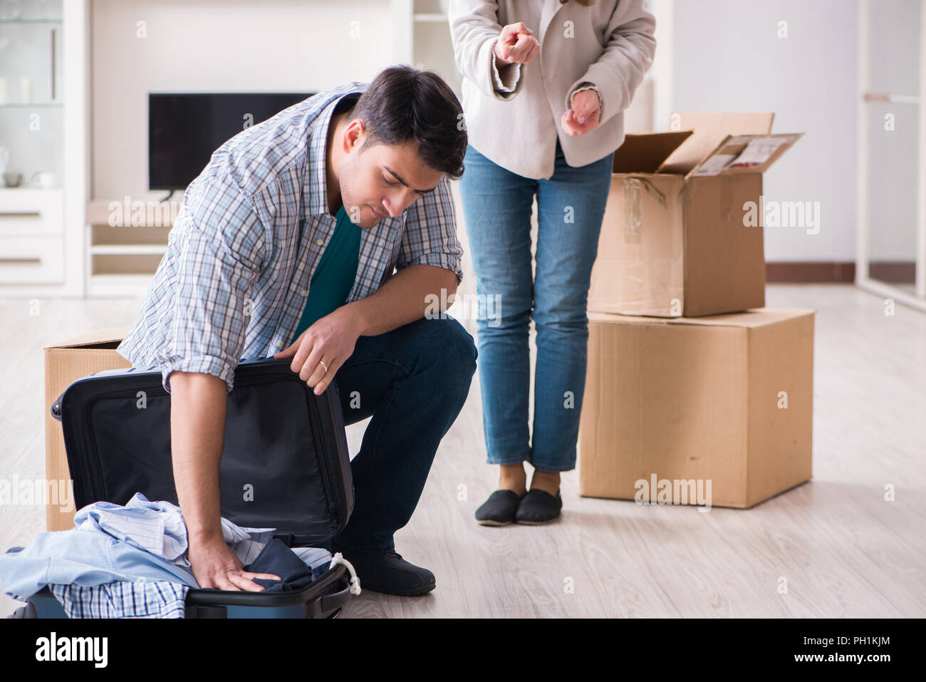 Woman evicting man from house during family conflict Stock Photo - Alamy
