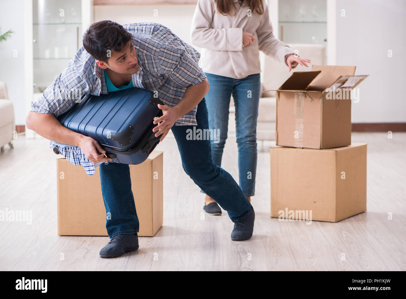 Woman evicting man from house during family conflict Stock Photo - Alamy