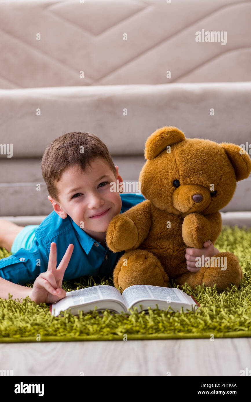 Small boy reading books at home Stock Photo - Alamy