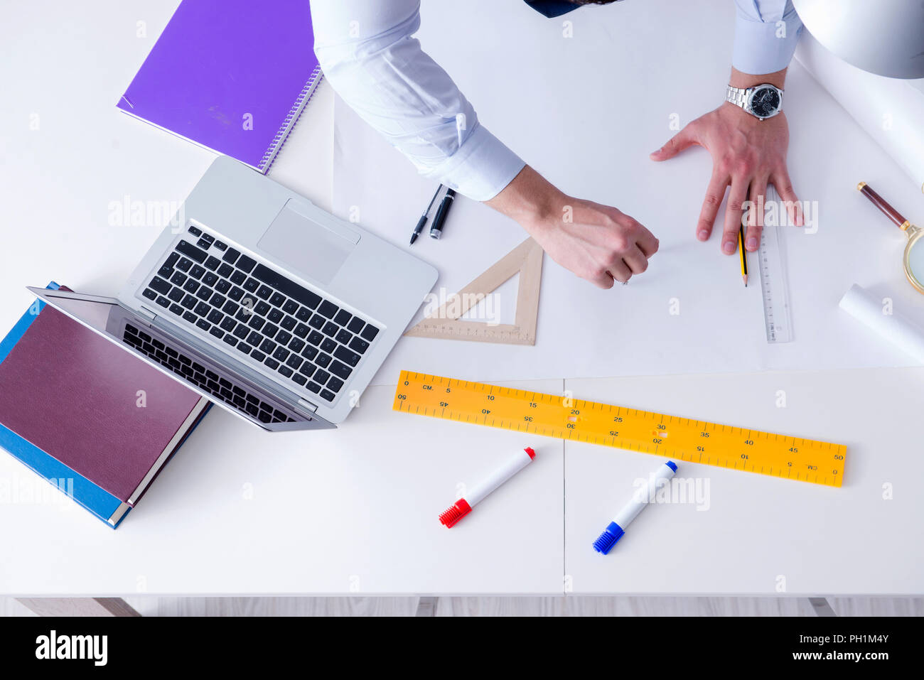 Engineer working on new project drawings Stock Photo - Alamy