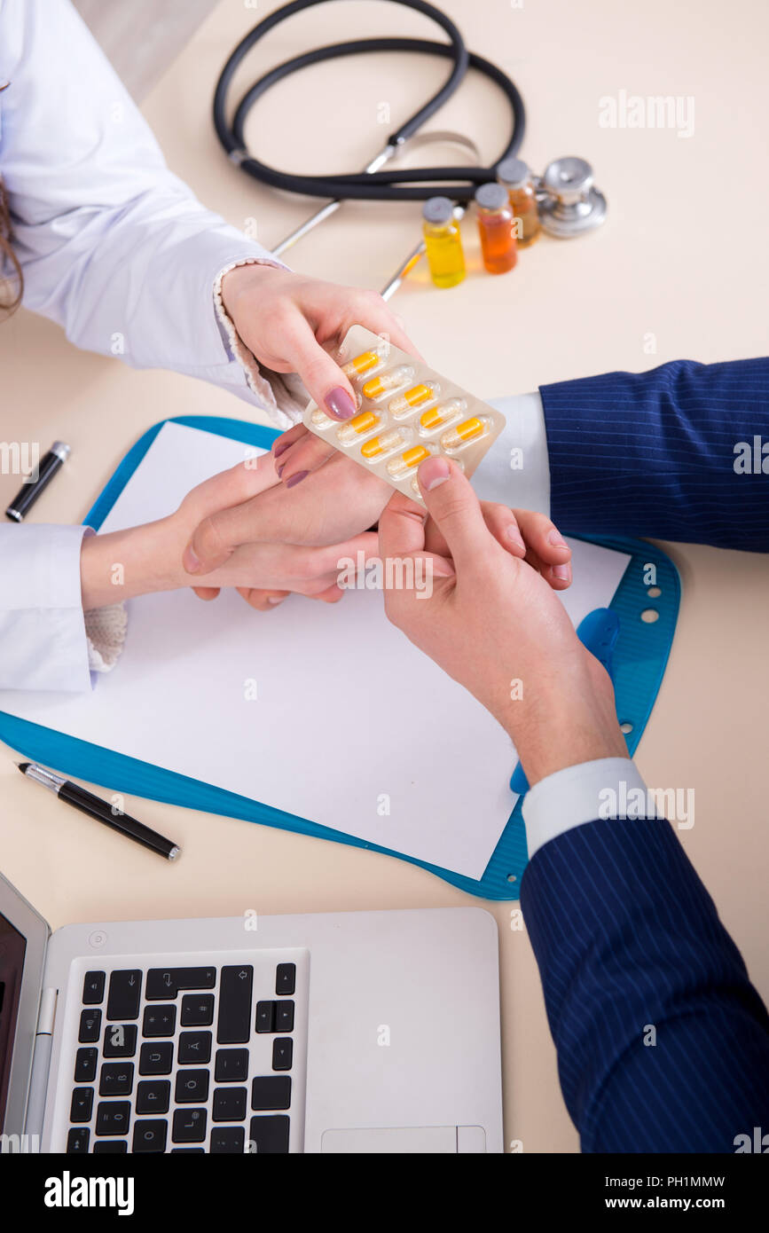 Doctor visiting shaking hands hi-res stock photography and images - Alamy
