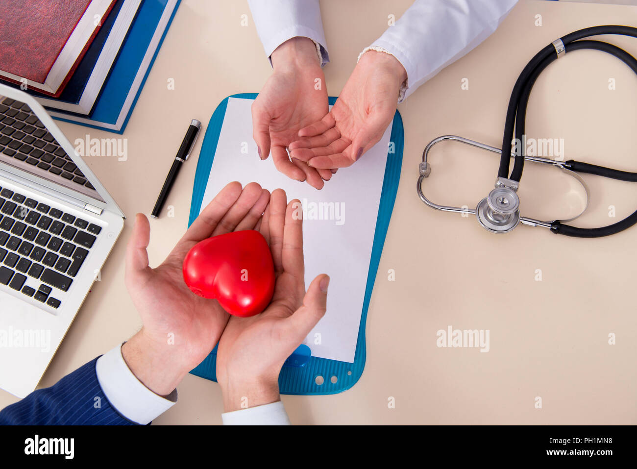 Businessman visiting cardiologist for routine check-up Stock Photo - Alamy