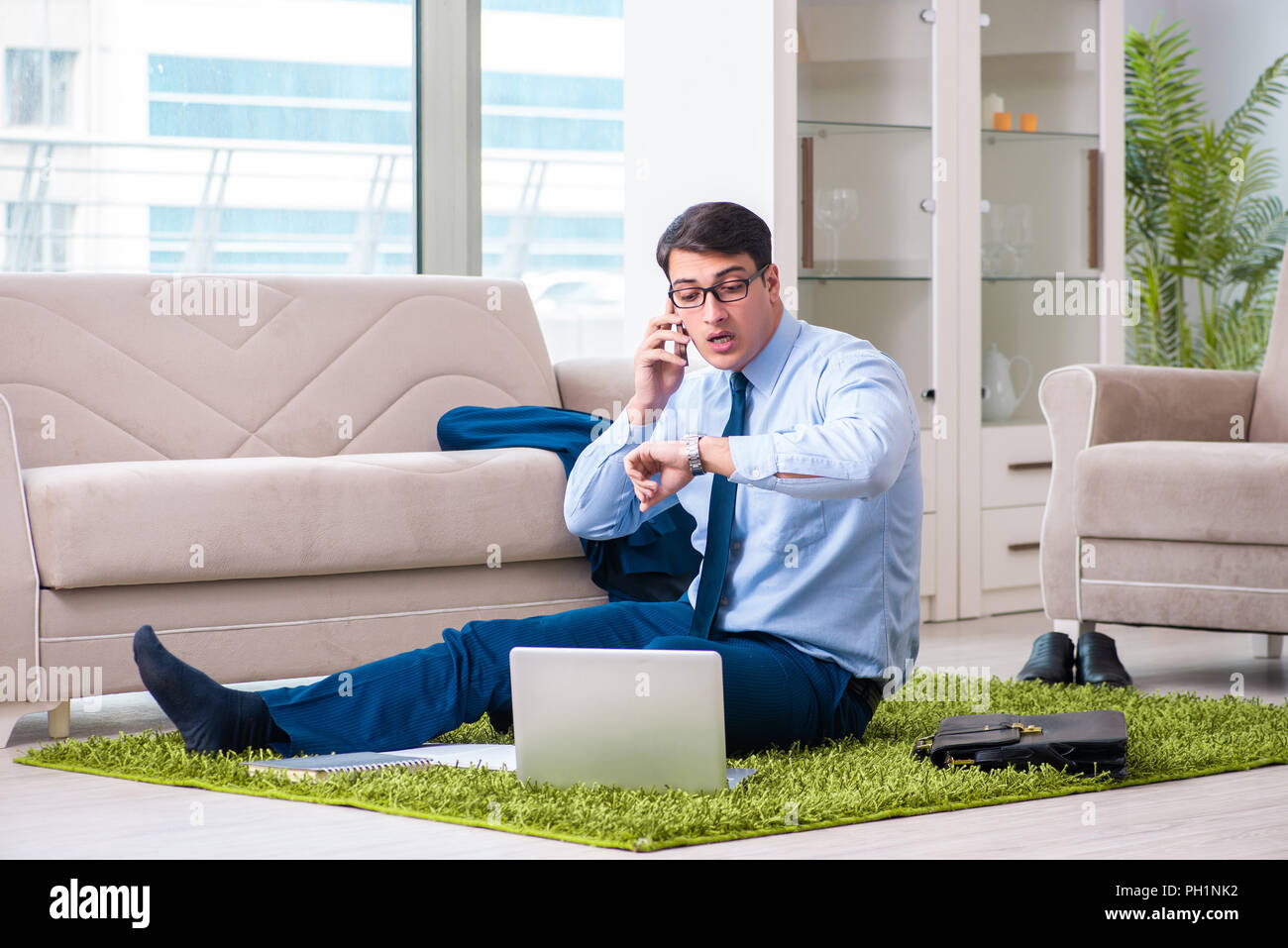 Businessman taking work home and working overtime Stock Photo - Alamy