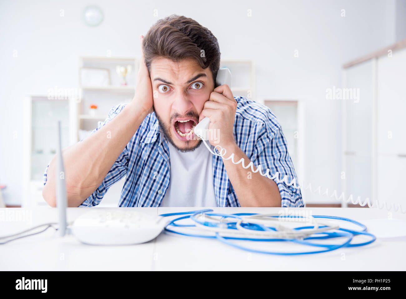 Frustrated young man due to weak internet reception Stock Photo - Alamy