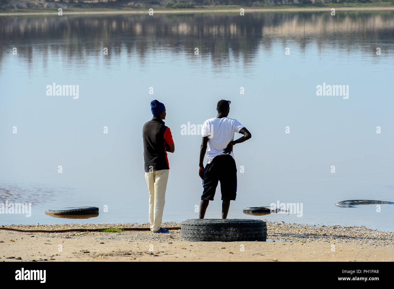 LAC ROSE, SENEGAL - APR 26, 2017: Unidentified Senegalese two men stand ...