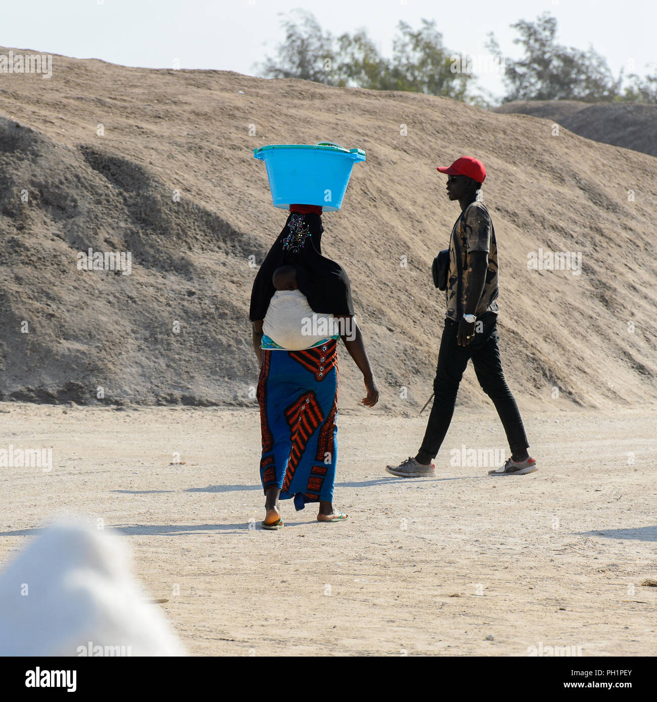 LAC ROSE, SENEGAL - APR 26, 2017: Unidentified Senegalese woman carries ...