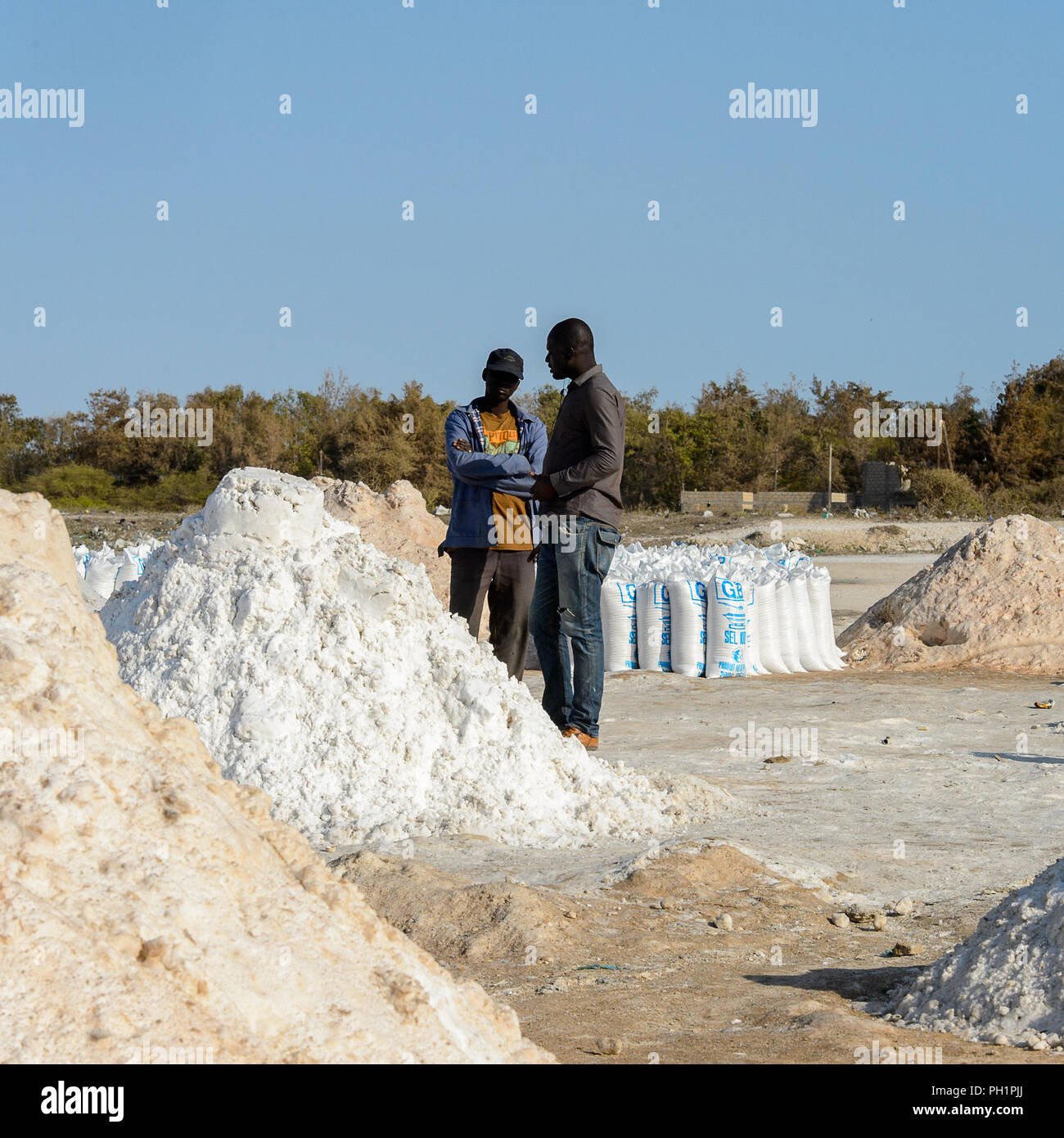 LAC ROSE, SENEGAL - APR 26, 2017: Unidentified Senegalese two men stand ...