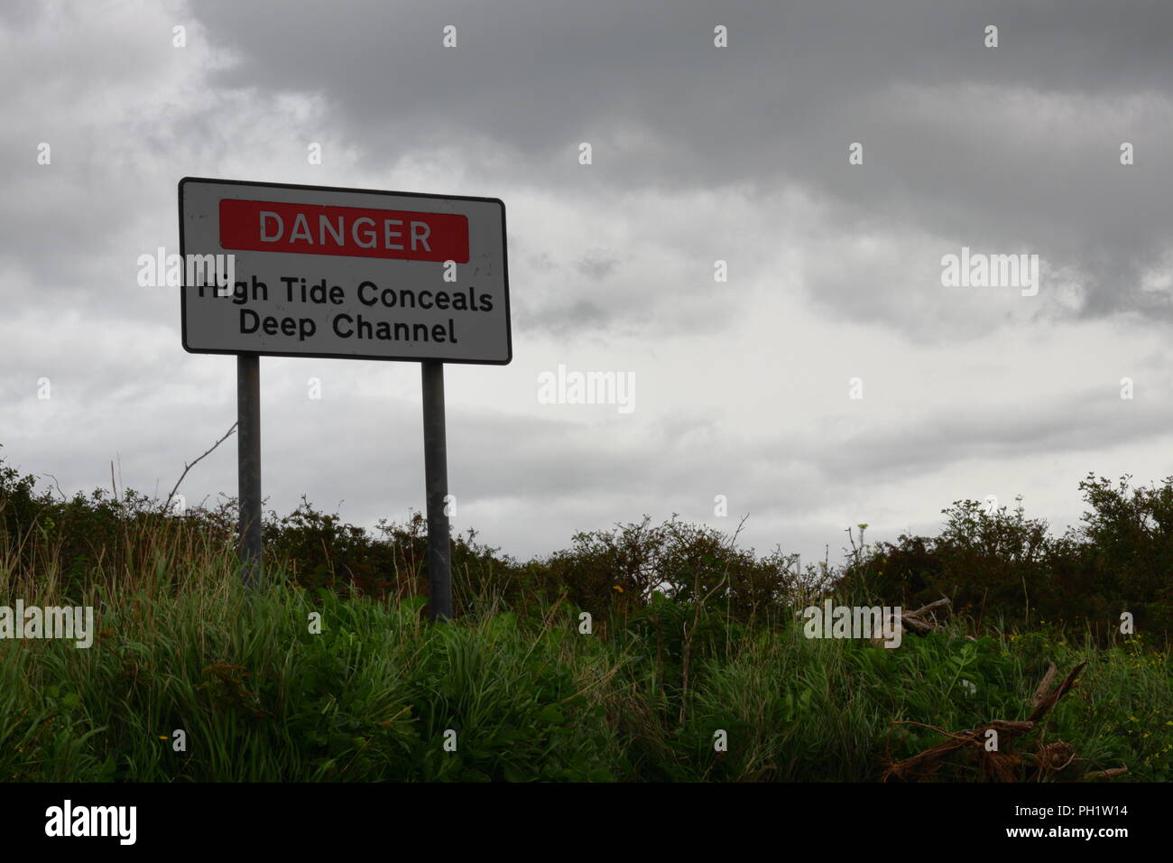 Danger sign and cloudy sky Stock Photo - Alamy